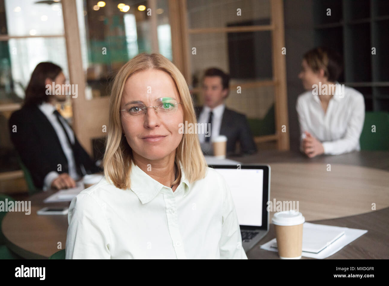 Portrait of female team leader posing looking at camera Stock Photo - Alamy