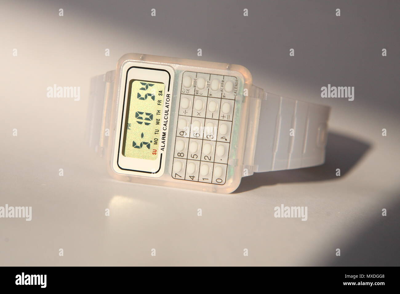 A retro style digital watch with calculator, in a clear plastic strap ...