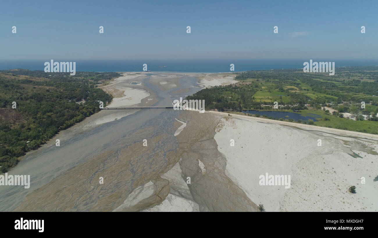 Mountain river Bucao flowing into the sea in Philippines,Luzon. Aerial ...