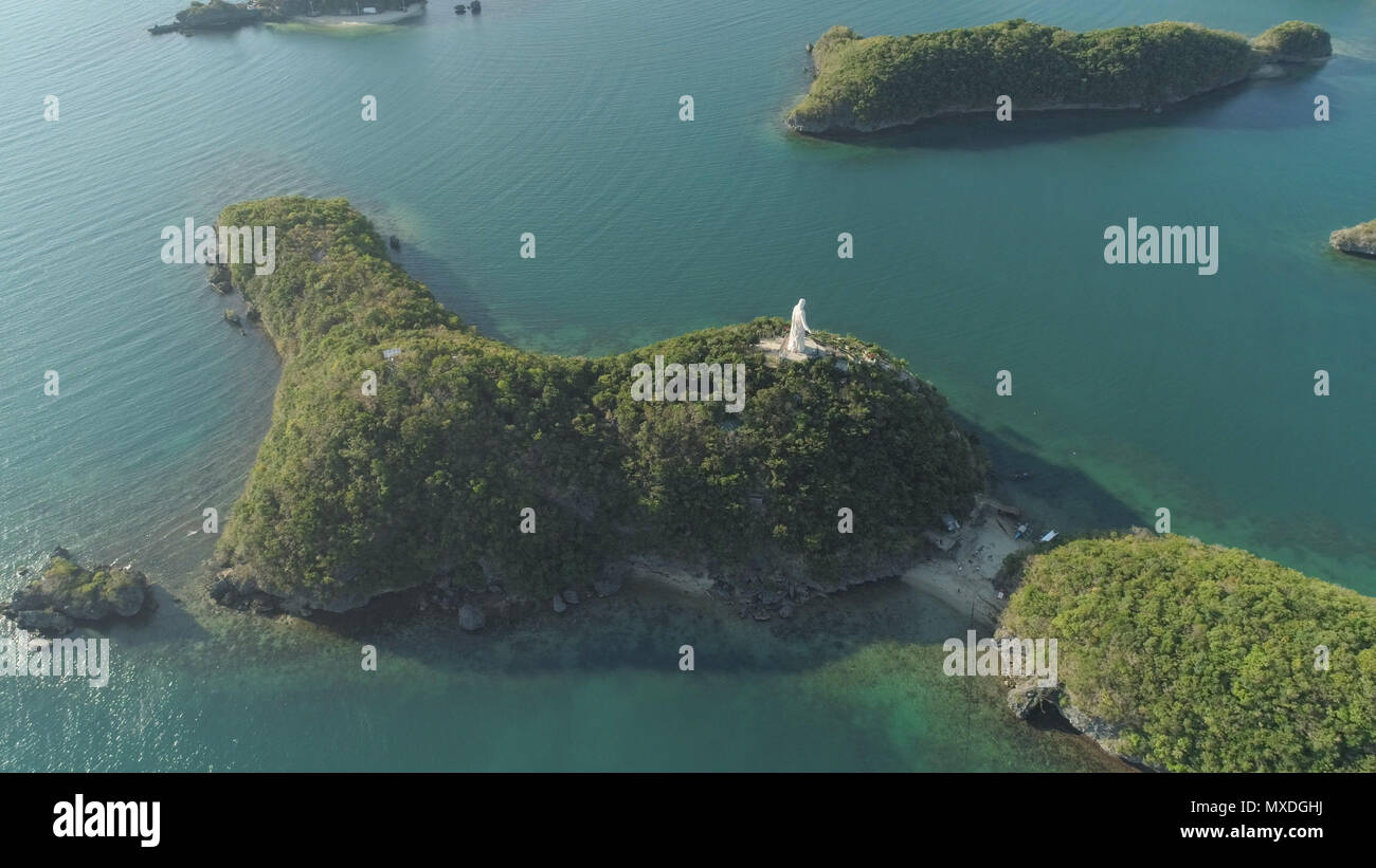 Small islands in Hundred Islands National Park with statue of Jesus ...