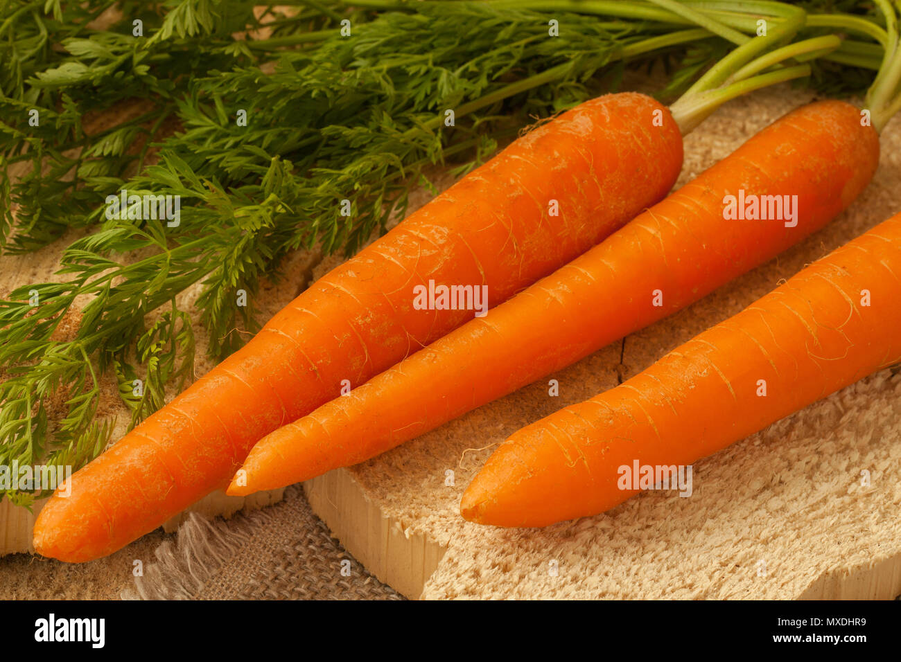 Organic carrots on a natural wooden background, farm food, GMO free ...