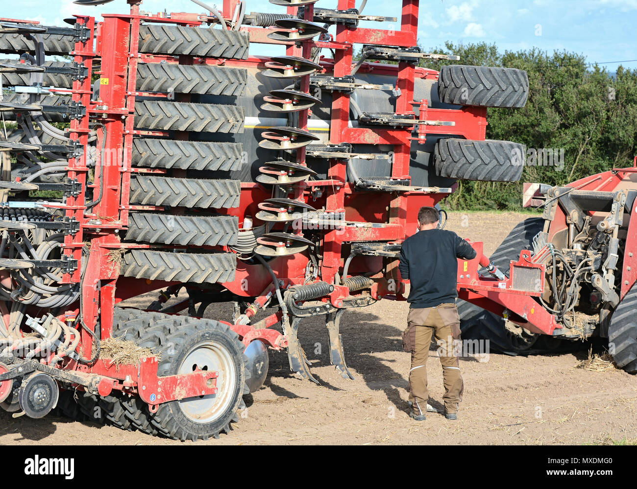 Farmer during the repair of a machine Stock Photo - Alamy