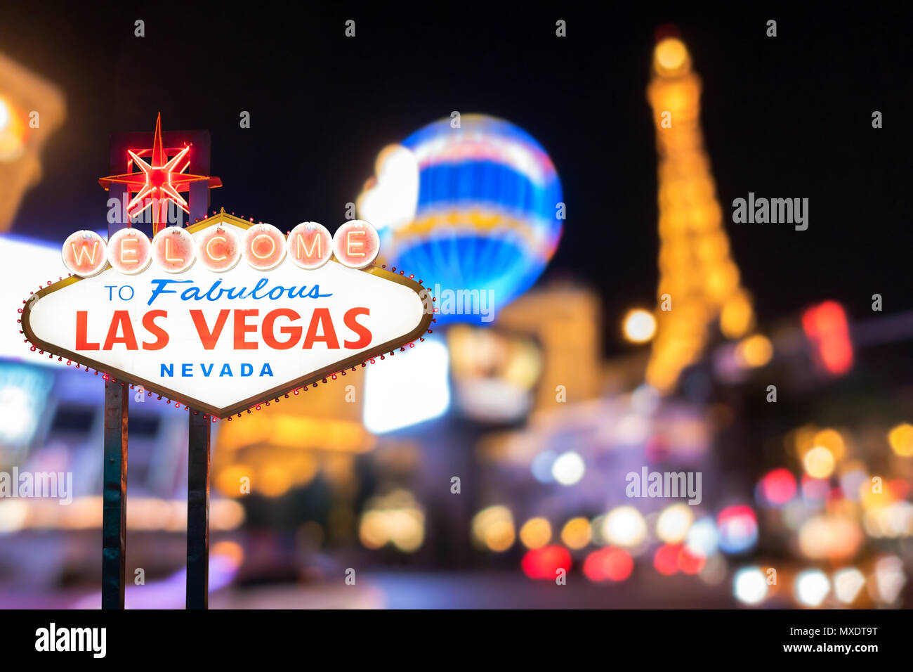 Famous Las Vegas sign at night with Las Vegas Cityscape blur background ...
