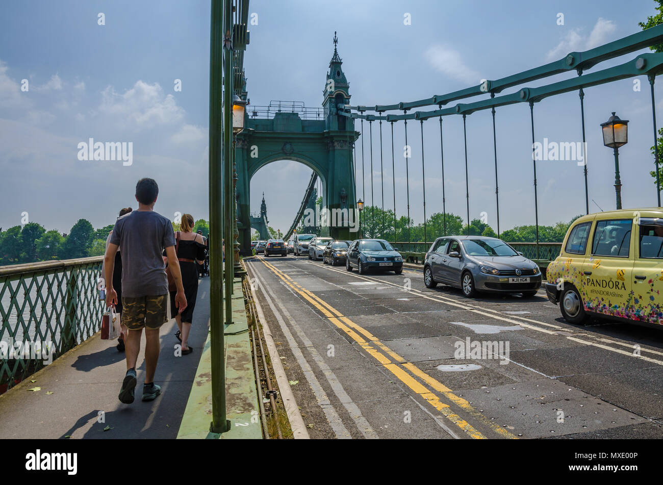 Traffic And Pedestrians On Hammersmith Suspension Bridge In London Uk