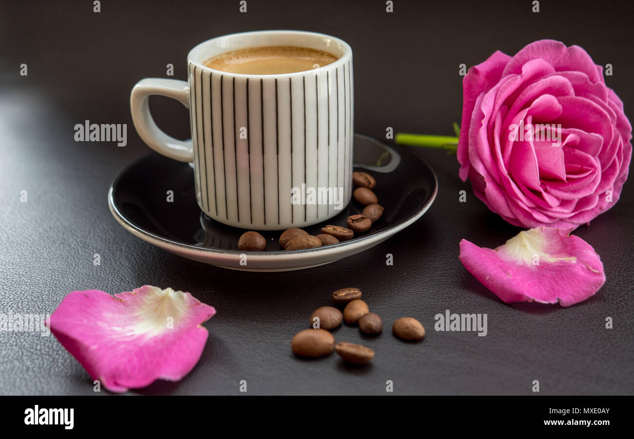 coffee with pink rose on dark leather surface with coffee beans Stock ...