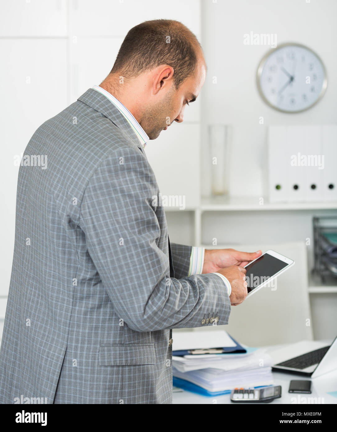 Male testing modern middle size touchpad in the office Stock Photo - Alamy
