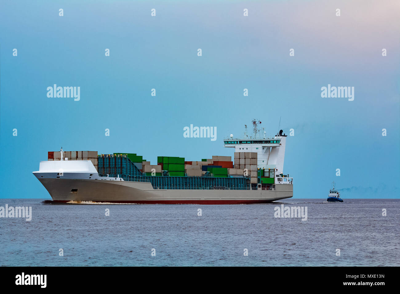 Grey container ship. Logistics and production import Stock Photo - Alamy