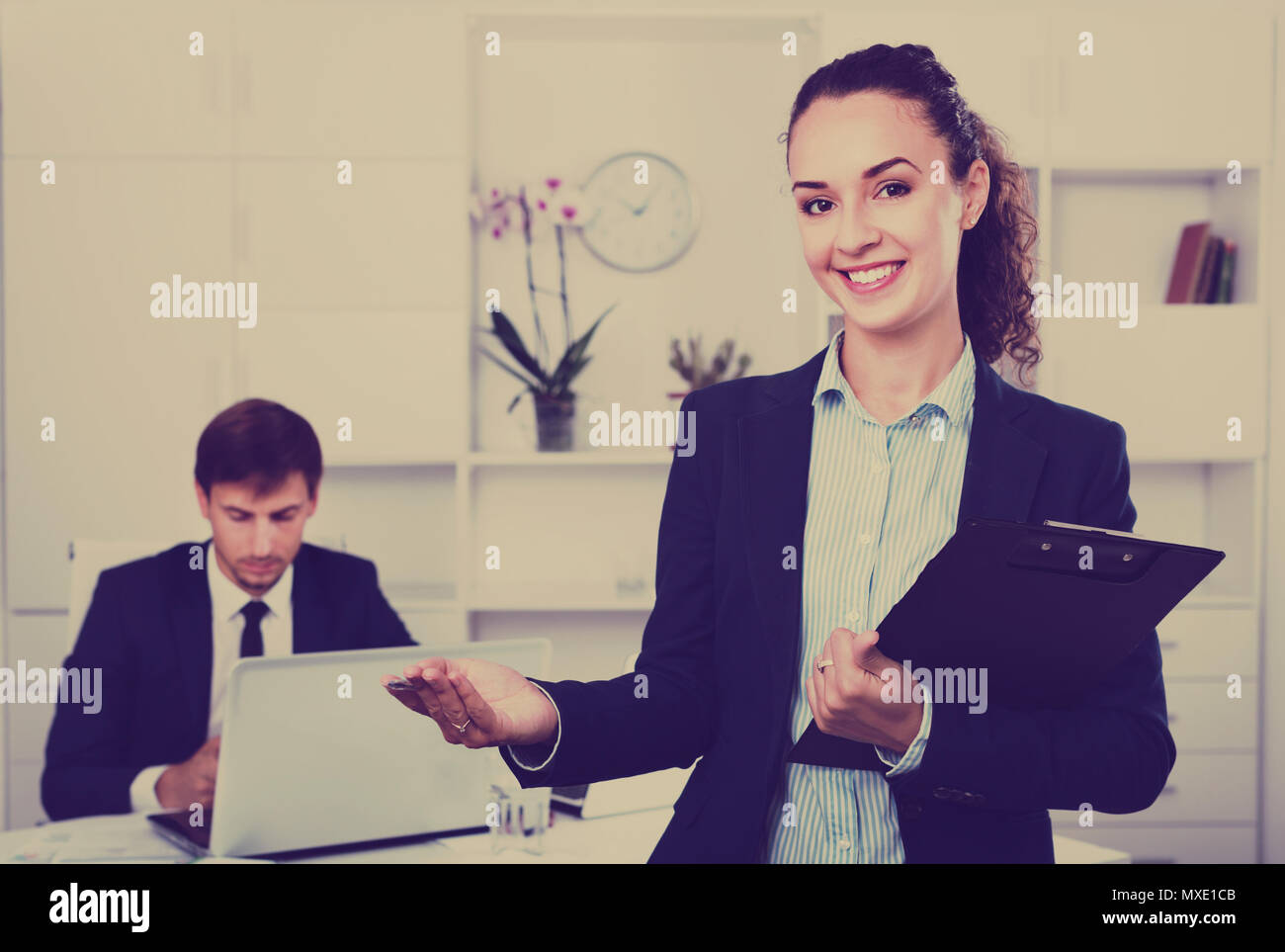 Glad friendly efficient business female secretary having cardboard in ...