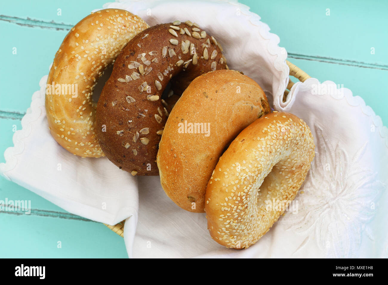 Selection of white and brown bagels in bread basket shot from the top ...