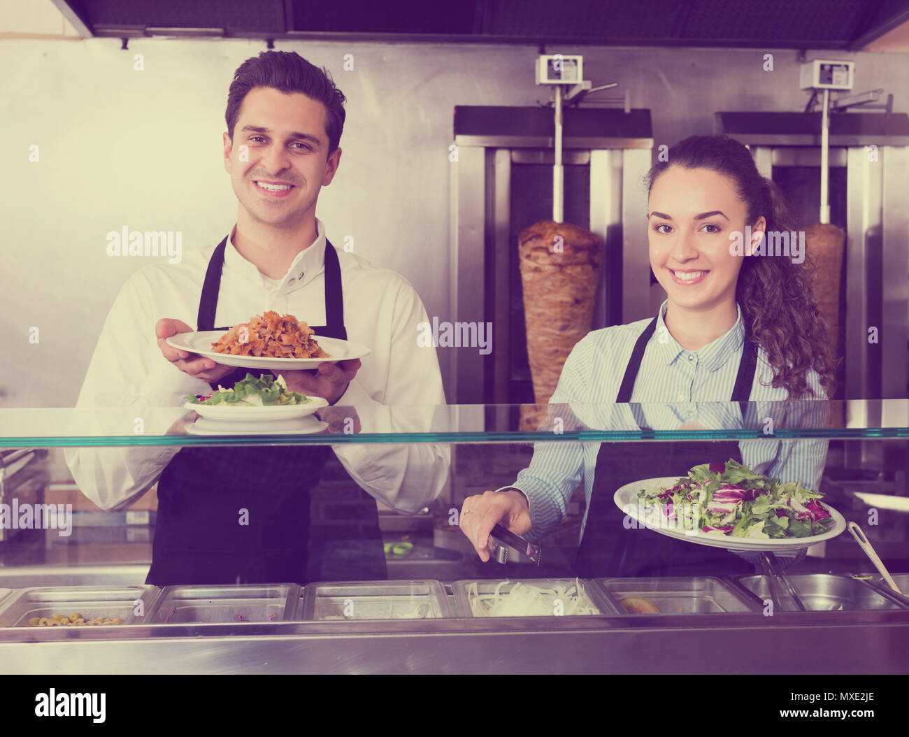 Adult restaurant staff posing at kebab counter and smiling Stock Photo ...