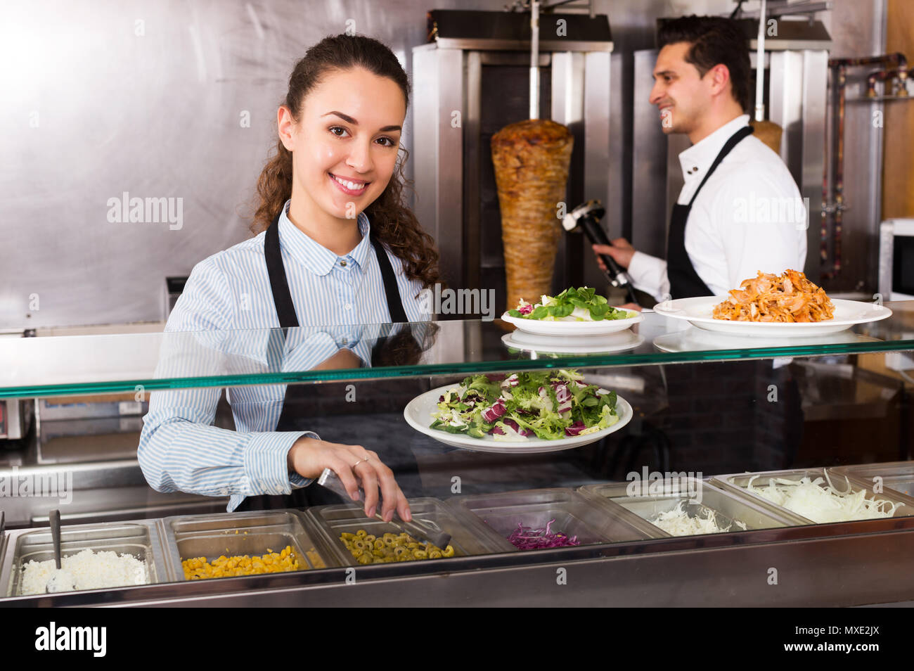 Happy young restaurant staff posing at kebab counter and smiling Stock ...