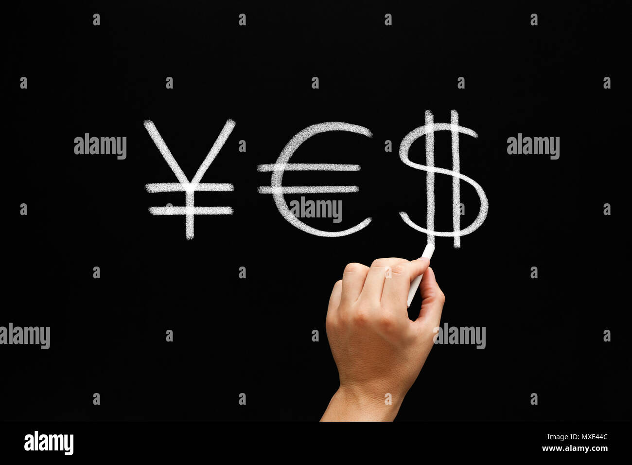 Hand writing YES with yen euro and dollar signs with white chalk on ...