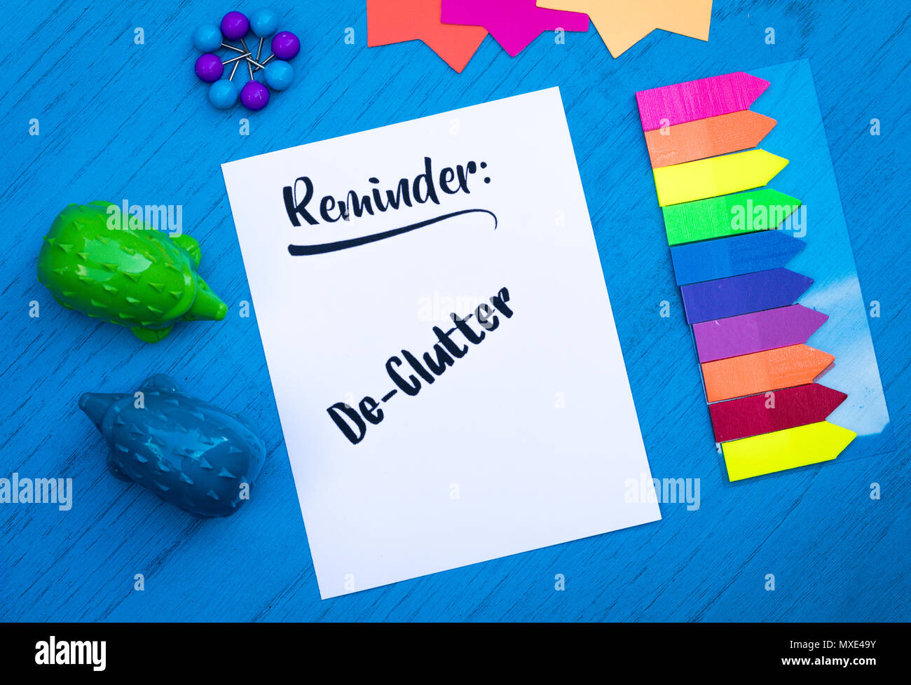 Reminder to De-Clutter still life motivational concept on white paper ...
