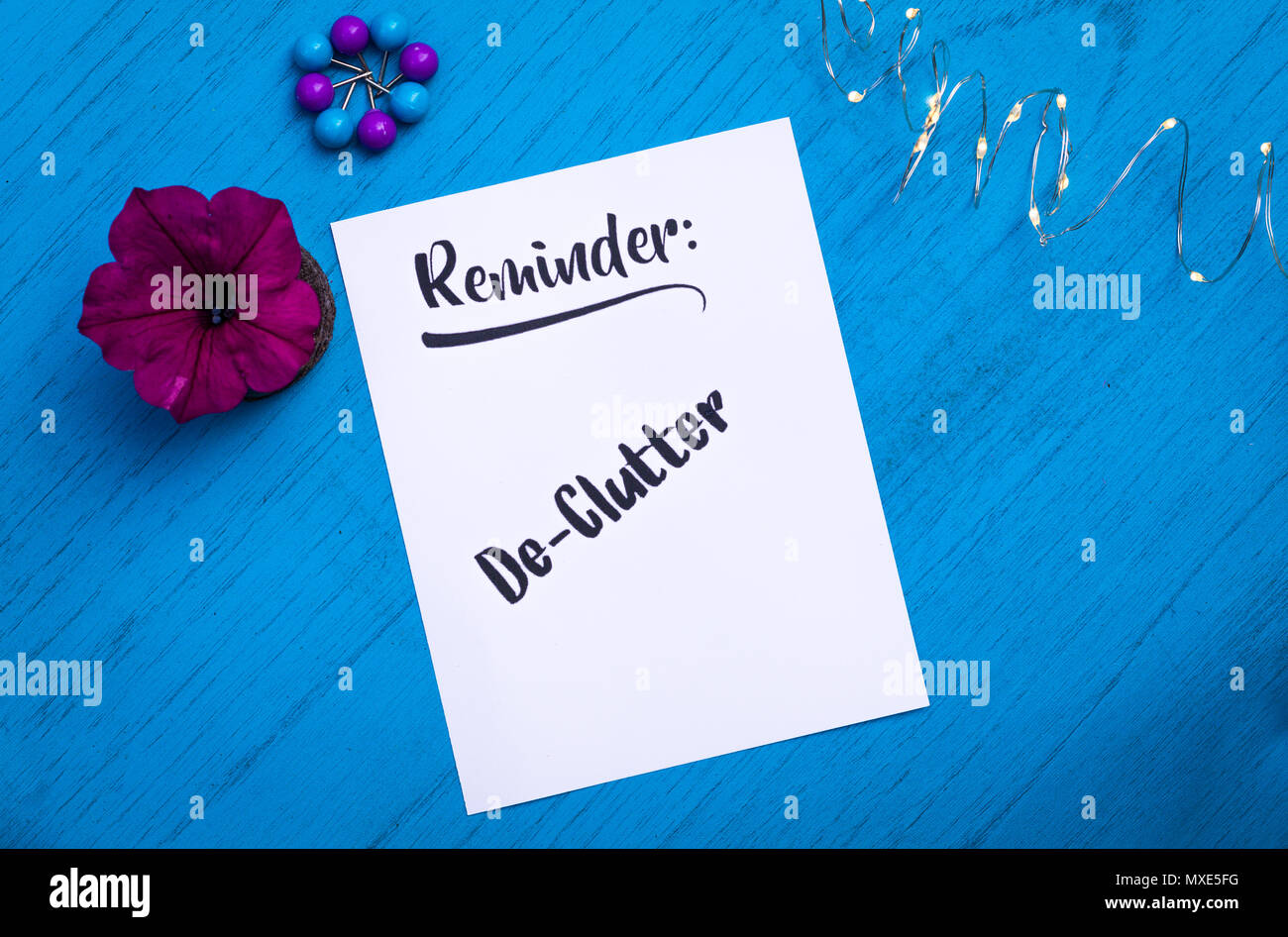 Reminder to De-Clutter still life motivational concept on white paper ...