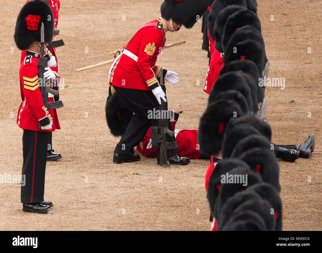 A soldier, overcome with heat, collapses and is stretchered off the ...