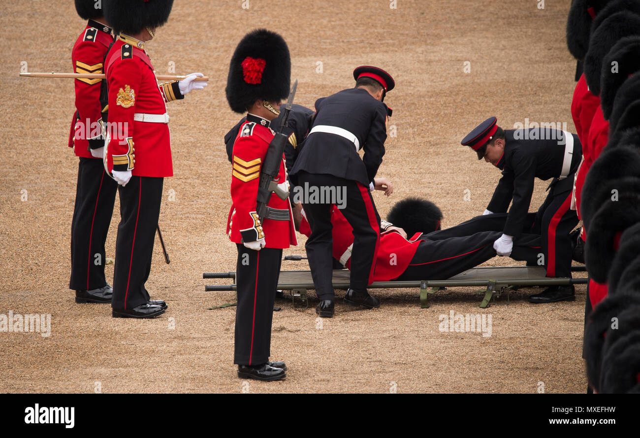 A soldier, overcome with heat, collapses and is stretchered off the ...
