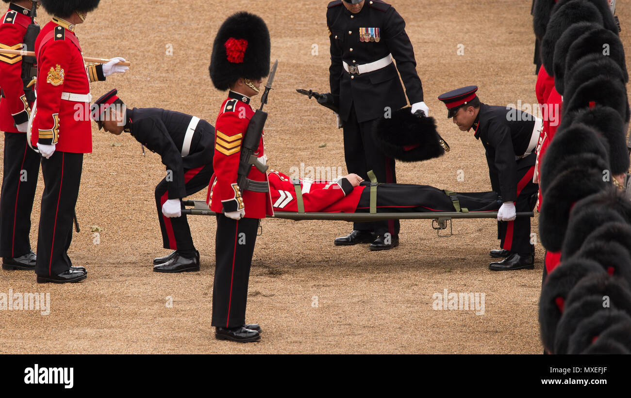 A soldier, overcome with heat, collapses and is stretchered off the ...