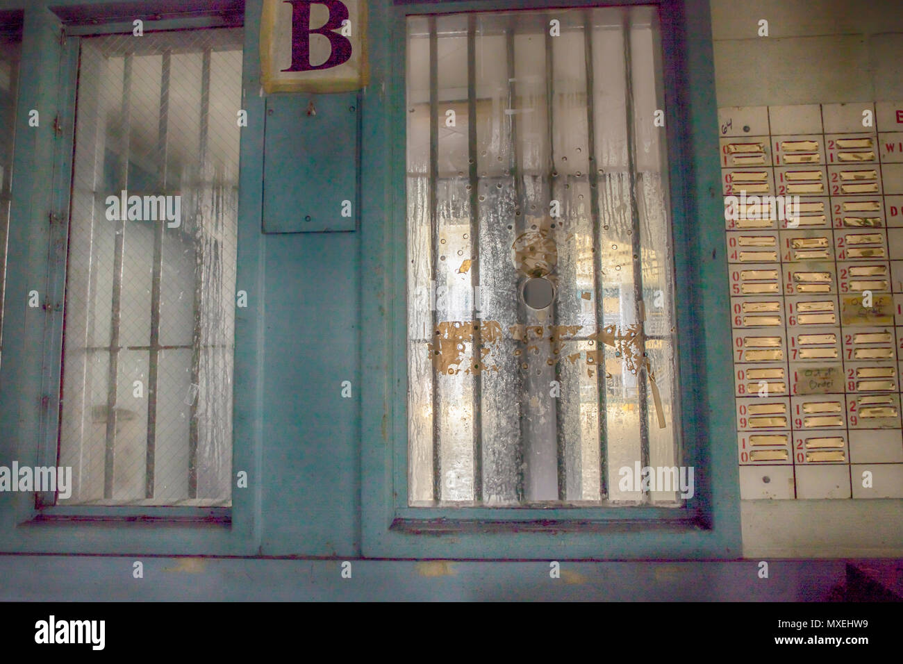View through bars on window from inside guard station to open cellblock ...