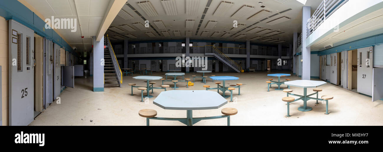 Common area inside abandoned prison cellblocks with open doors Stock ...