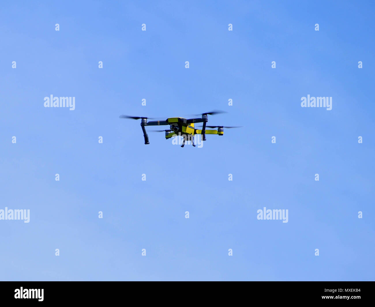 A remote controlled drone against a blue sky Stock Photo - Alamy