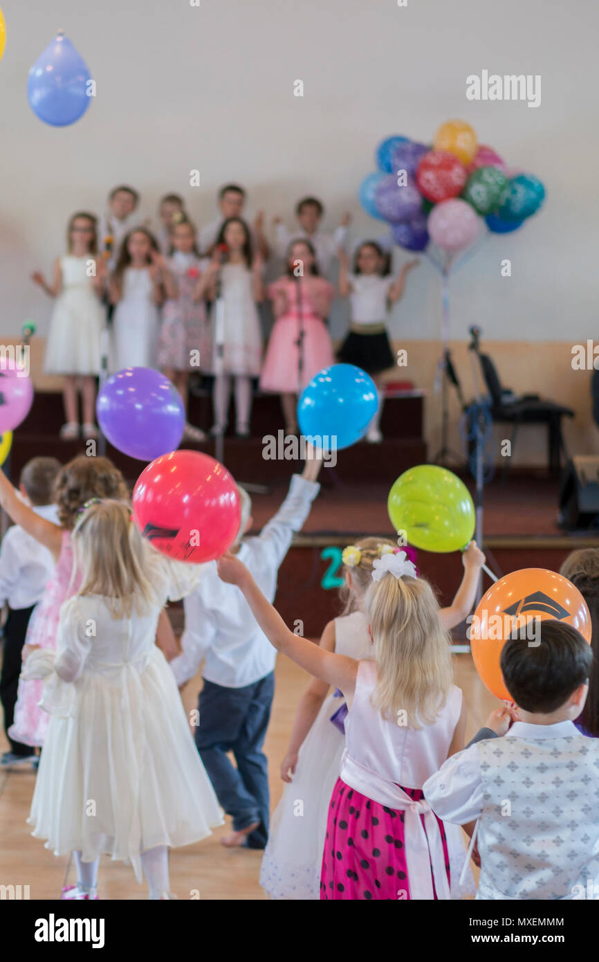 Children's holiday in kindergarten. Children on stage perform in front ...