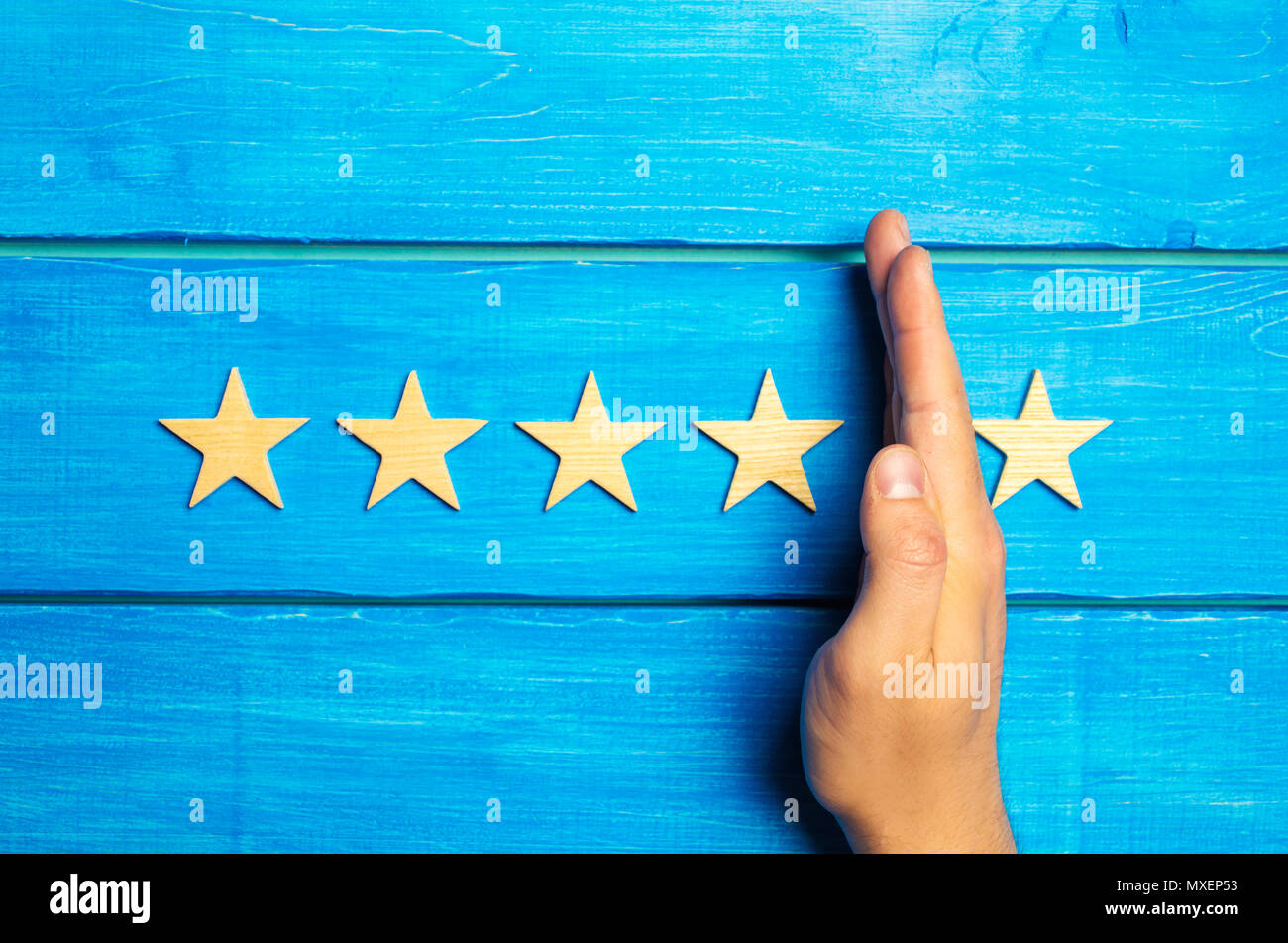 The hand divides the fifth star from the four others. Rating 5 stars, 4 ...