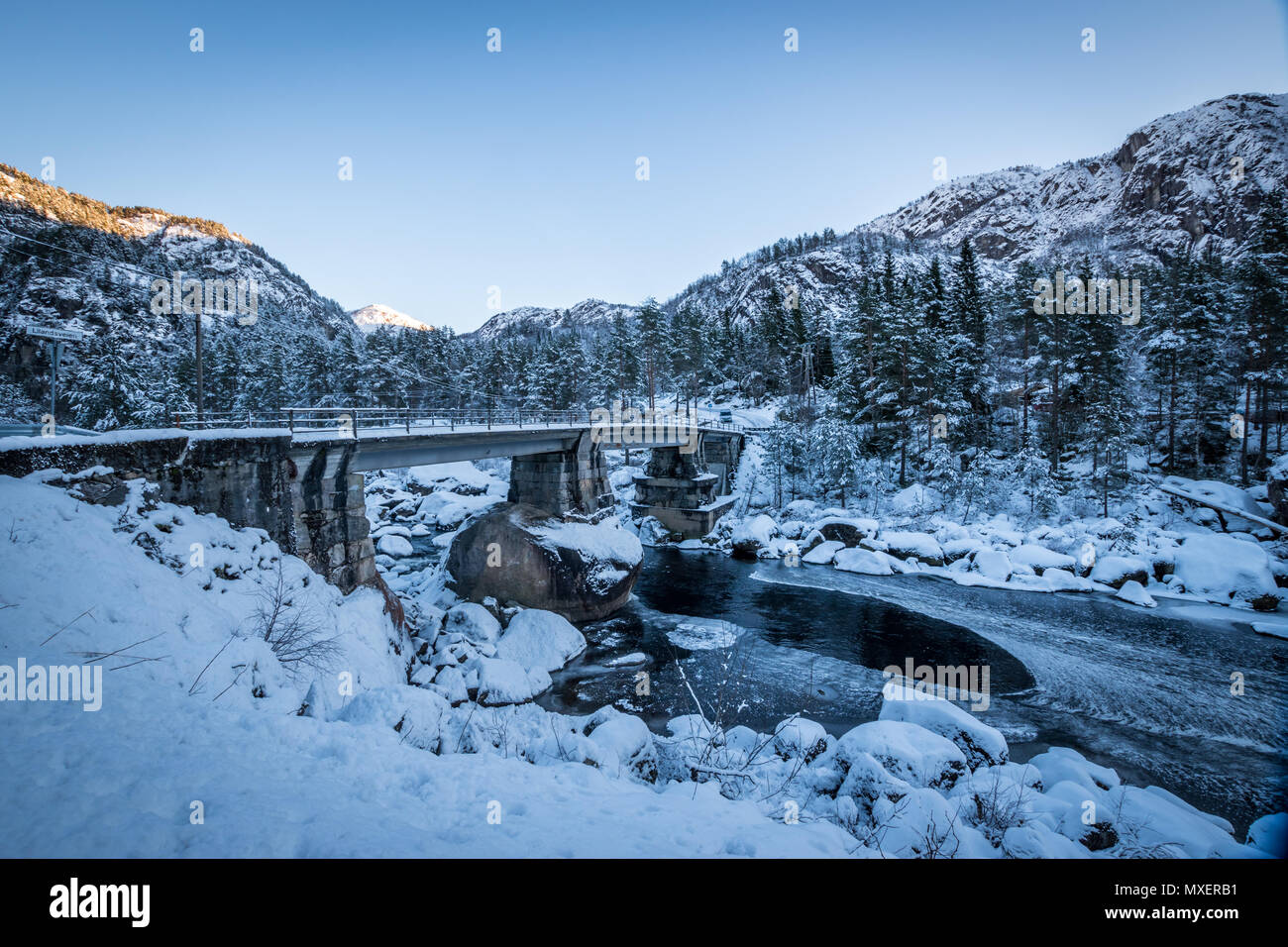Bridge over river big rock winter Stock Photo - Alamy