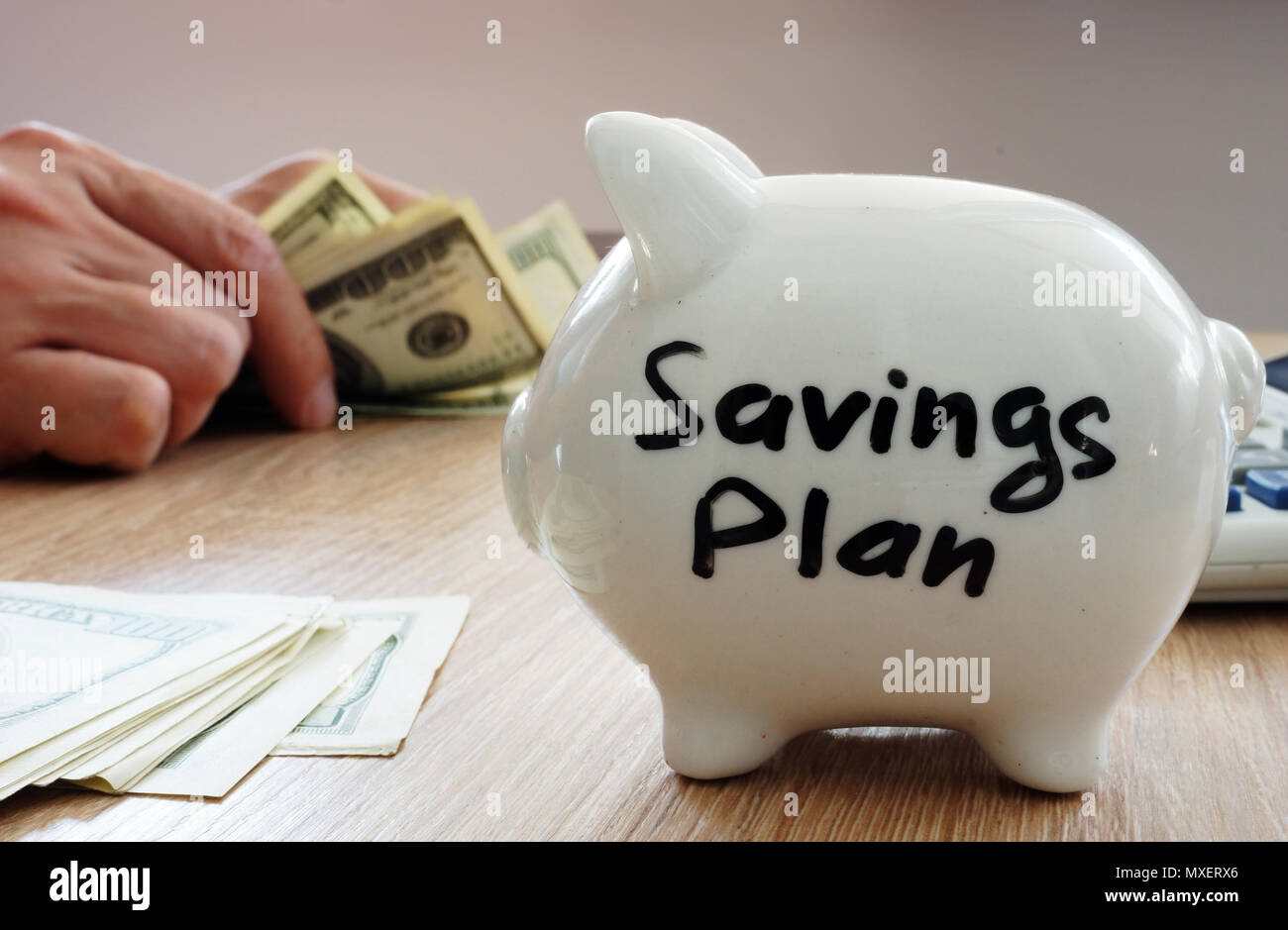 Savings Plan. Piggy bank and hands counting money Stock Photo - Alamy