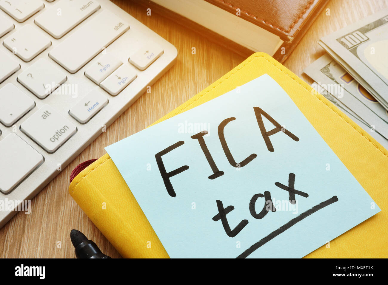 Stick with words fica tax and keyboard Stock Photo - Alamy