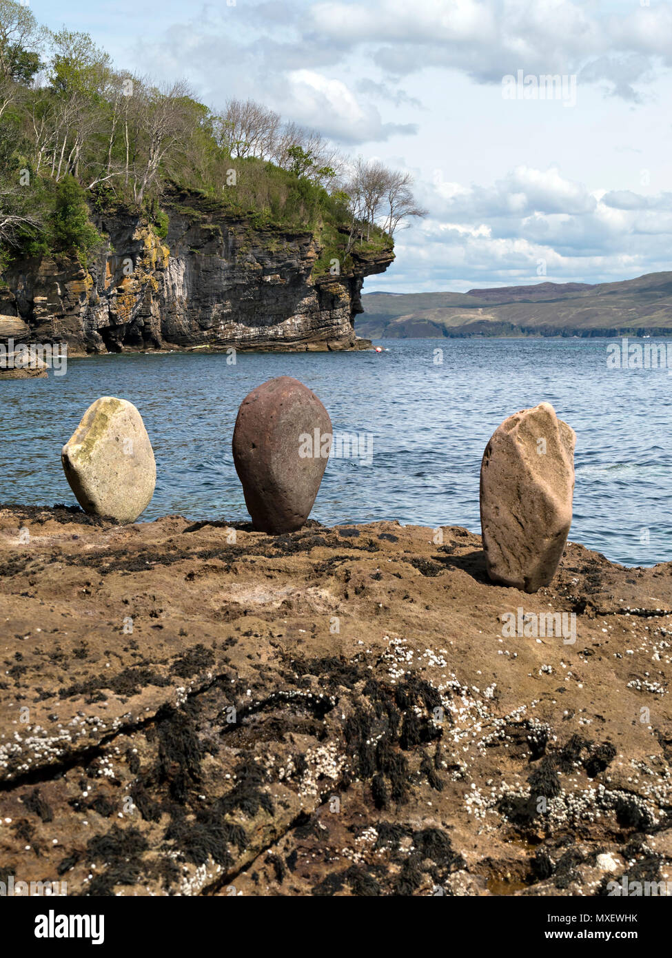 Balanced rocks sculpture with Loch Slapin and sea cliffs beyond ...