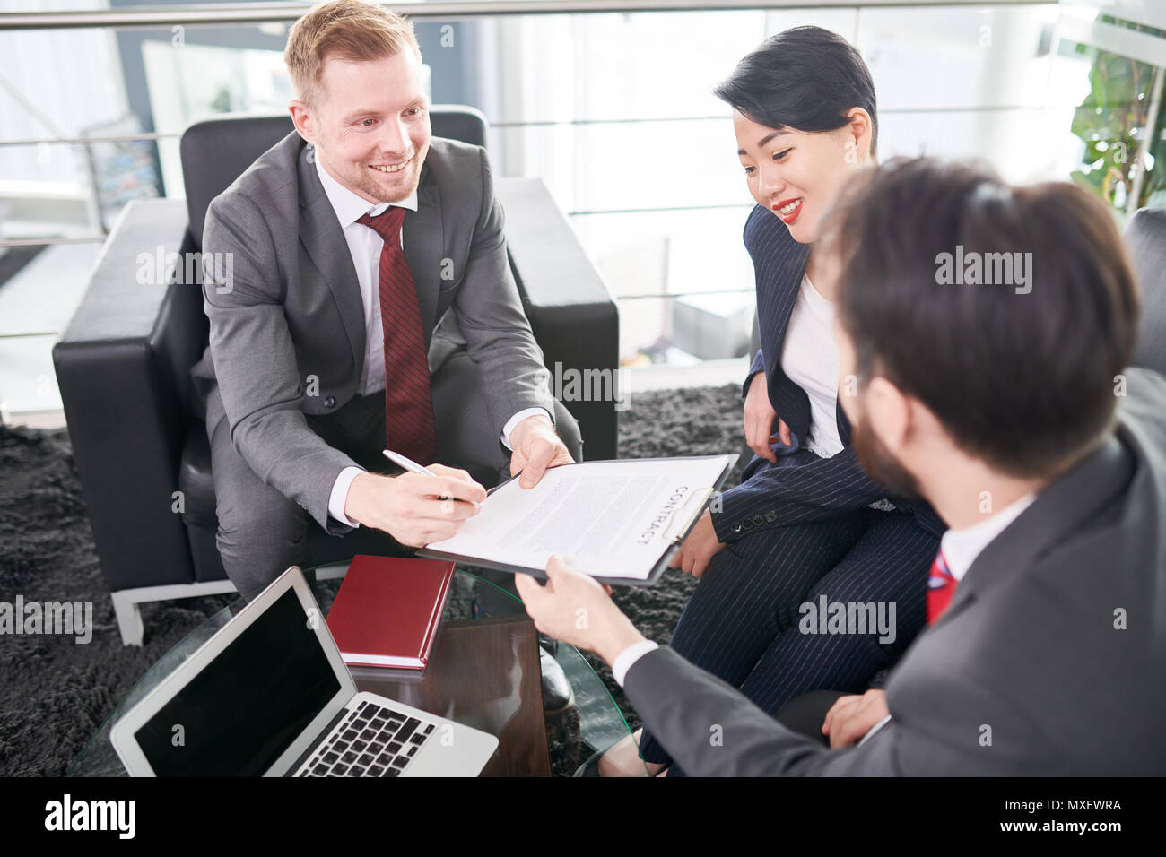 Signing Contract at Modern Boardroom Stock Photo - Alamy