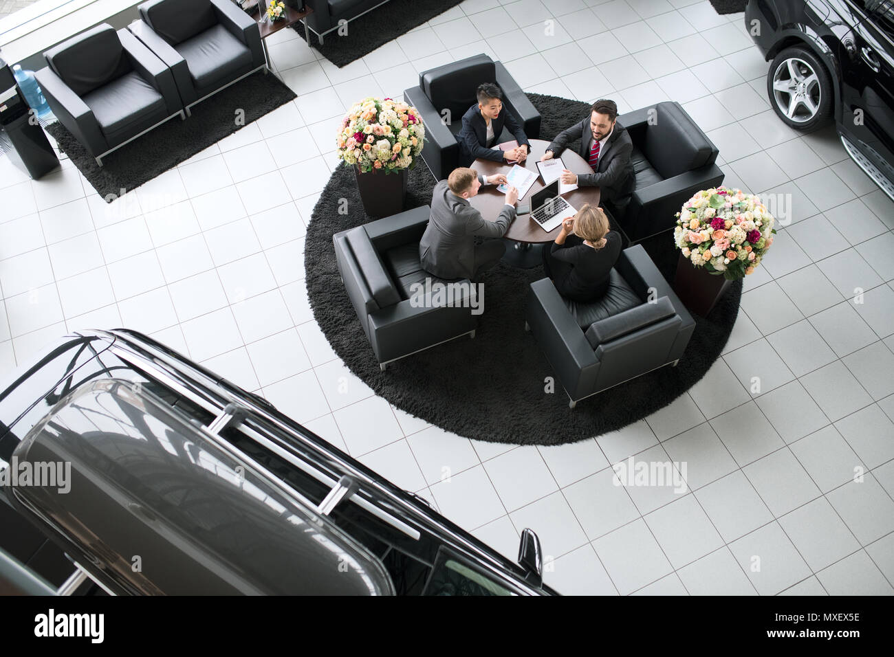 Conducting Negotiations at Car Showroom Stock Photo - Alamy