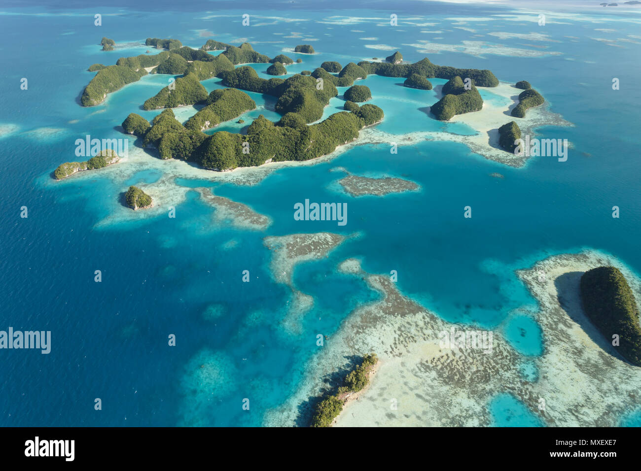 Aerial view of coral reefs, coral atolls, and islands surrounded by the ...