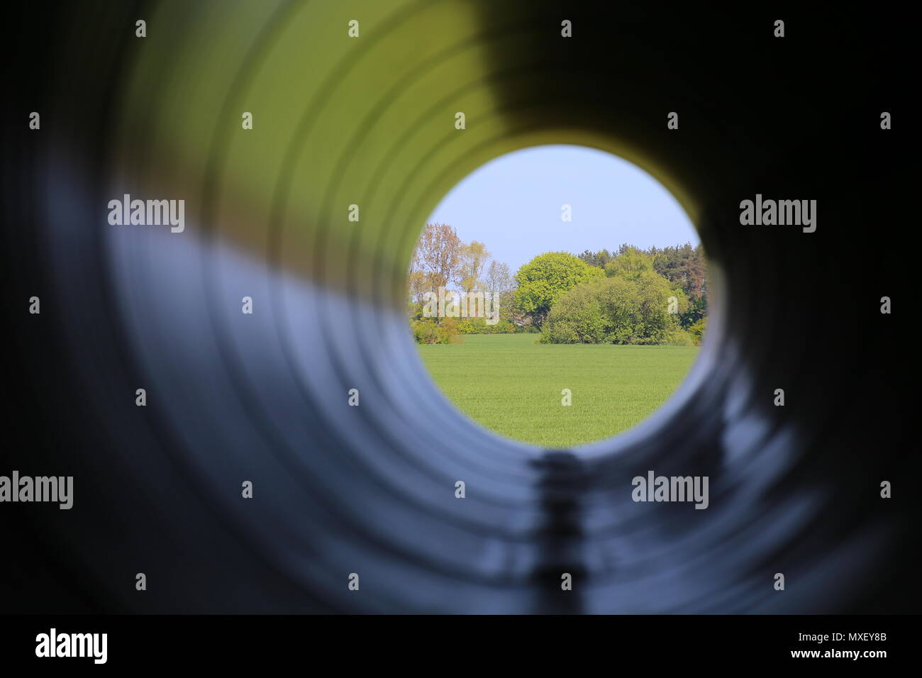 Unusual look through a big steel pipe Stock Photo - Alamy