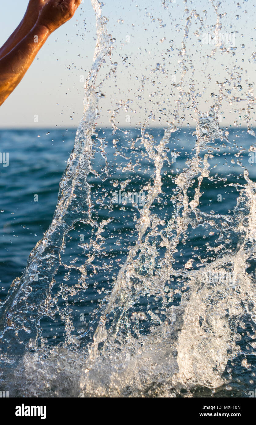 large transparent splashes sea water on a warm Sunny day, close-up ...