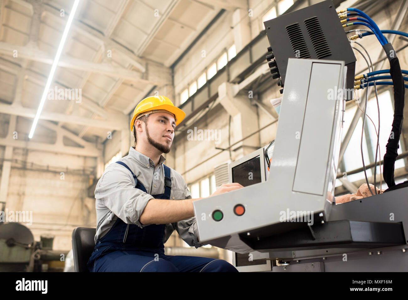 Machine Operator Wrapped up in Work Stock Photo - Alamy