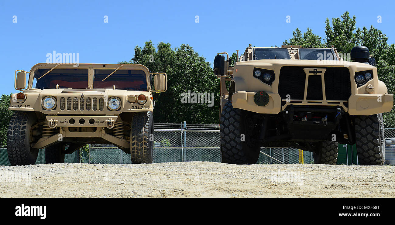A Humvee and a Joint Light Tactical Vehicle stand on display for size ...