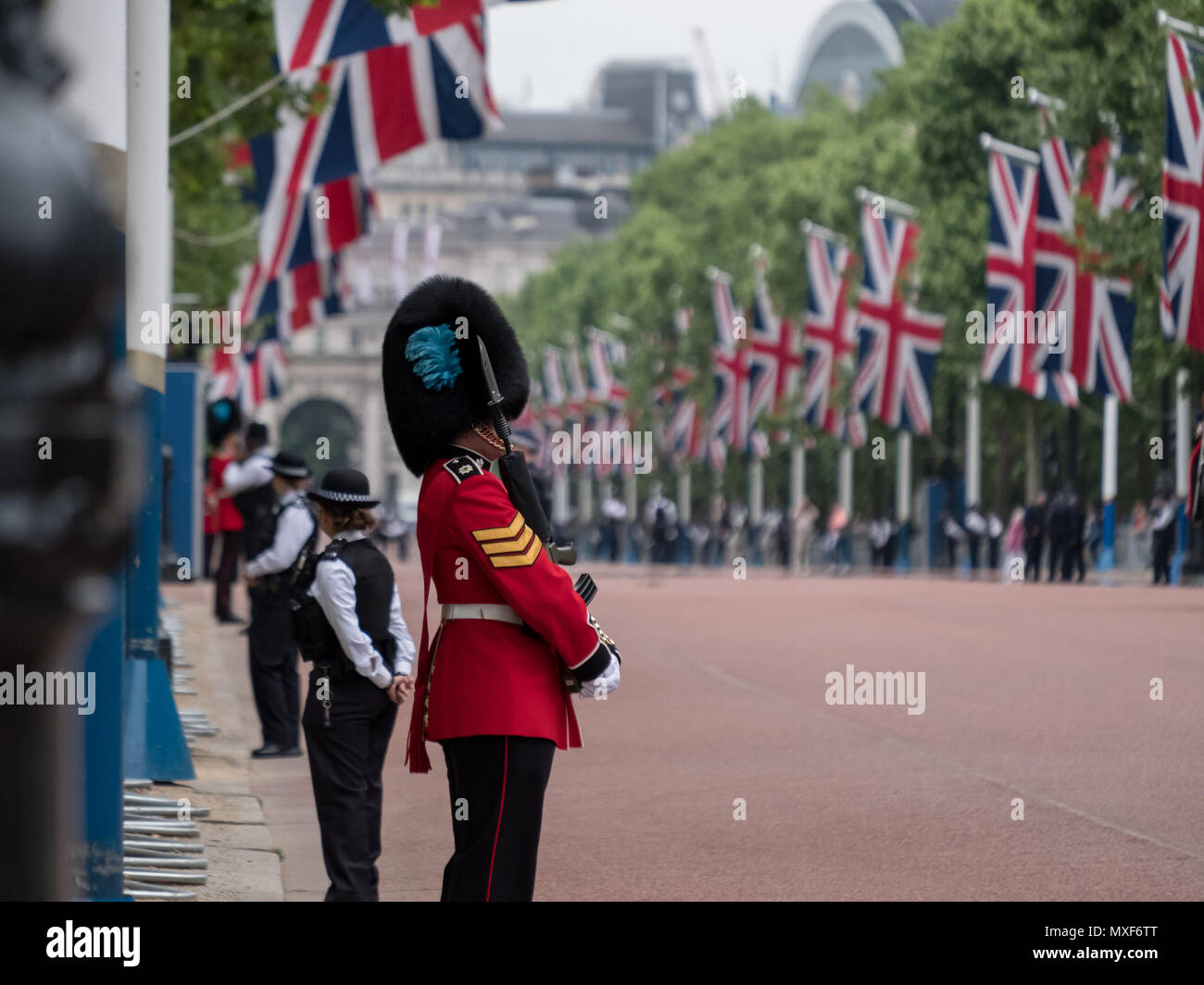 Amid tight security, guardsmen in red and black uniform and bearskins ...