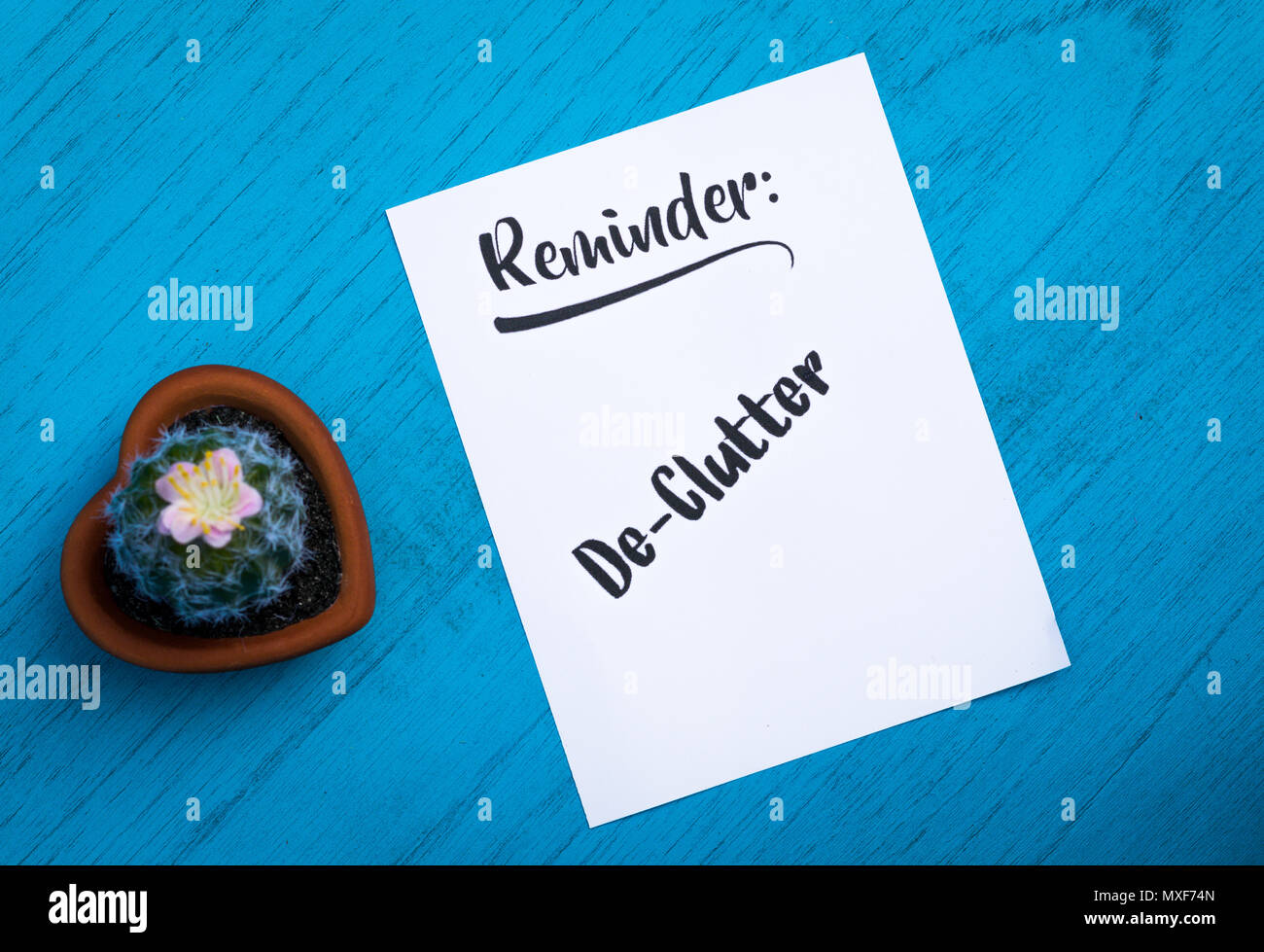 Reminder to De-Clutter still life motivational concept on white paper ...