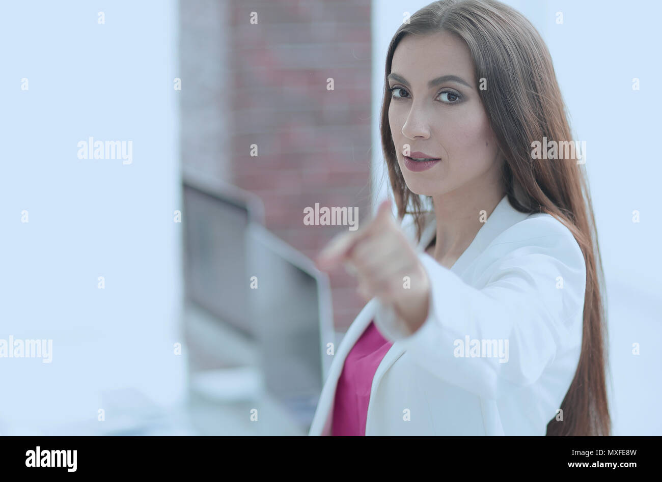 confident business woman pointing finger forward Stock Photo - Alamy