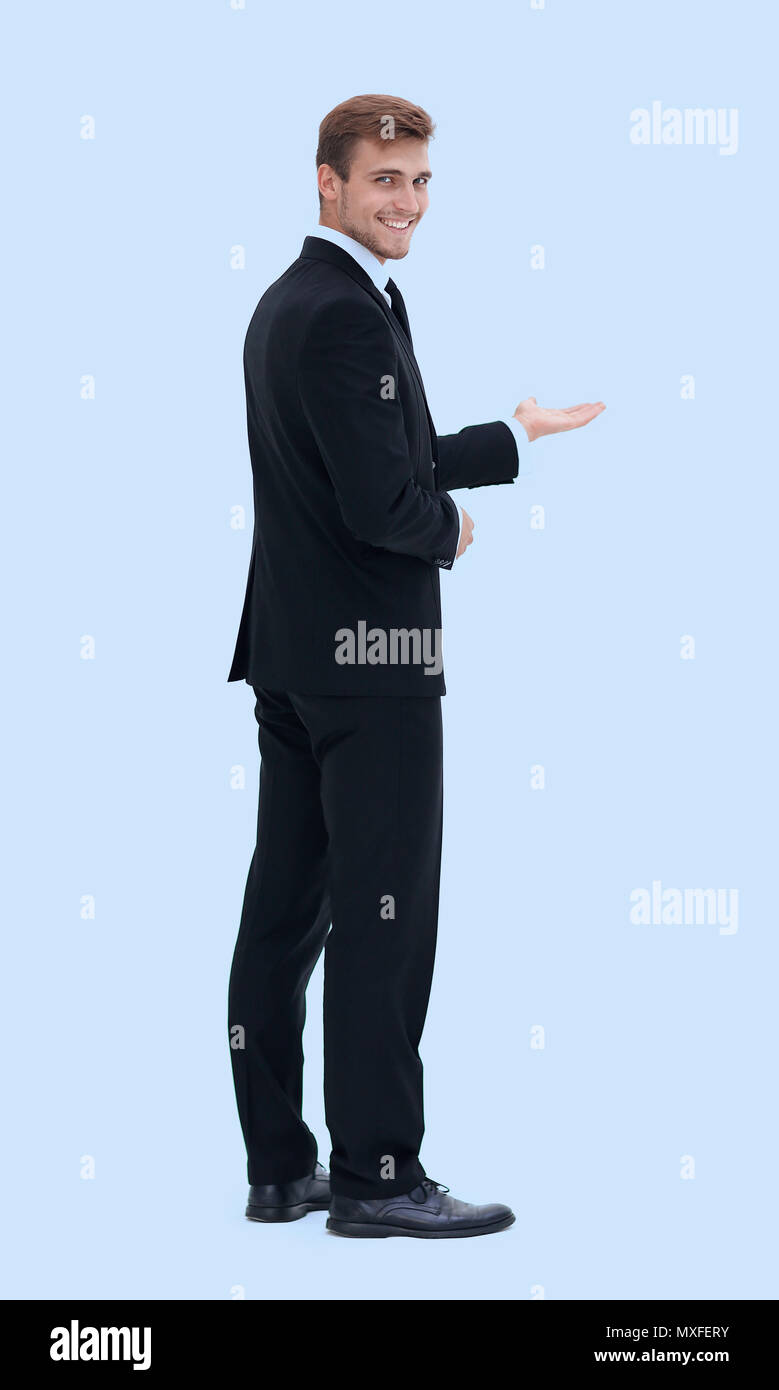 rear view.smiling businessman pointing forward. photo in full growth ...