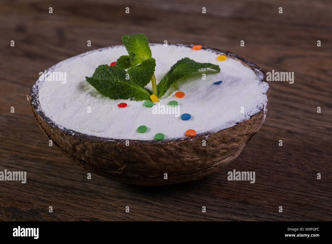 Ice-cream in cocoa nut with mint Stock Photo - Alamy