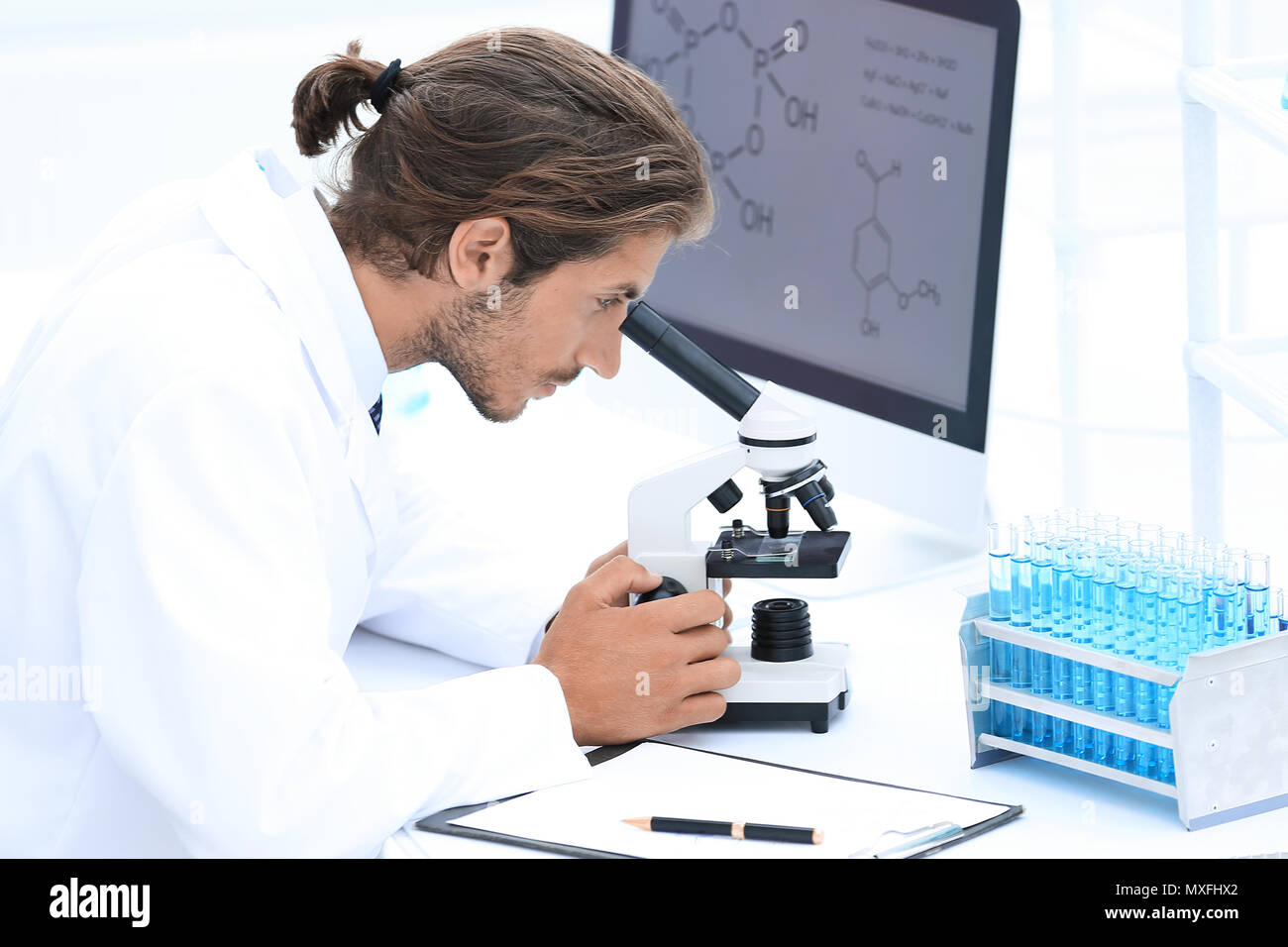 Lab scientist examining sample through hi-res stock photography and ...