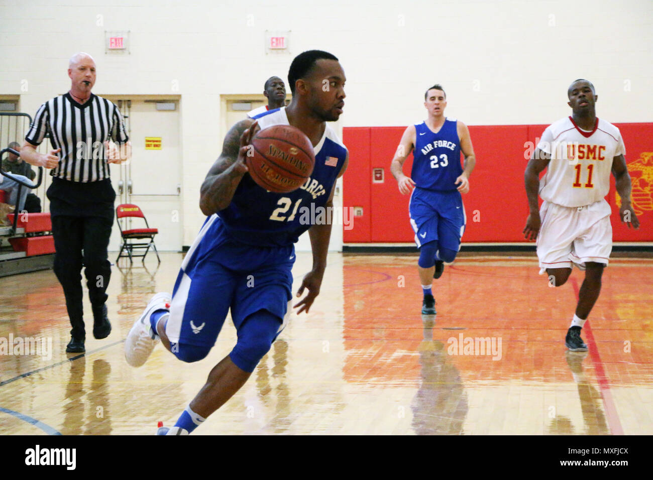 Senior Airman Daveon Allen of Nellis AFB, Nevada drives the lane during ...