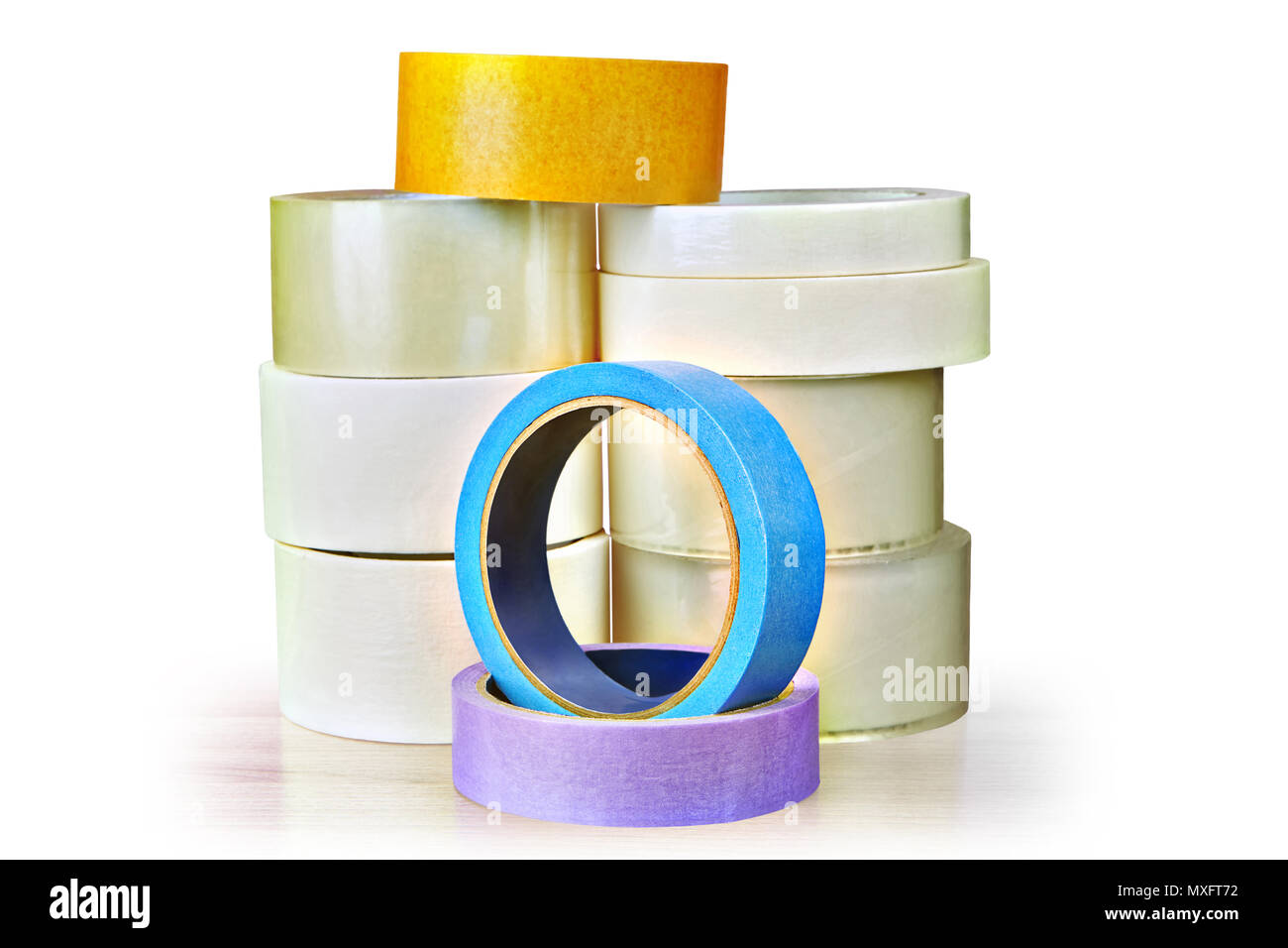 Paper and plastic sticky tape is stacked in assortment, white ...