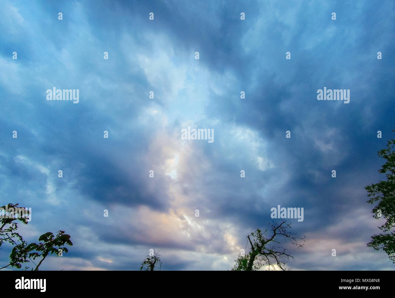 Cumulus sunset clouds with sun setting down Dramatic stormy clouds ...