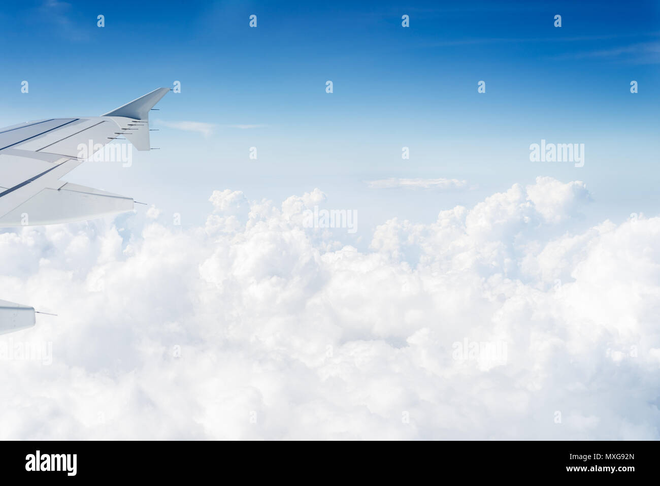 Skyline View above the Clouds from Airplane Window Stock Photo - Alamy