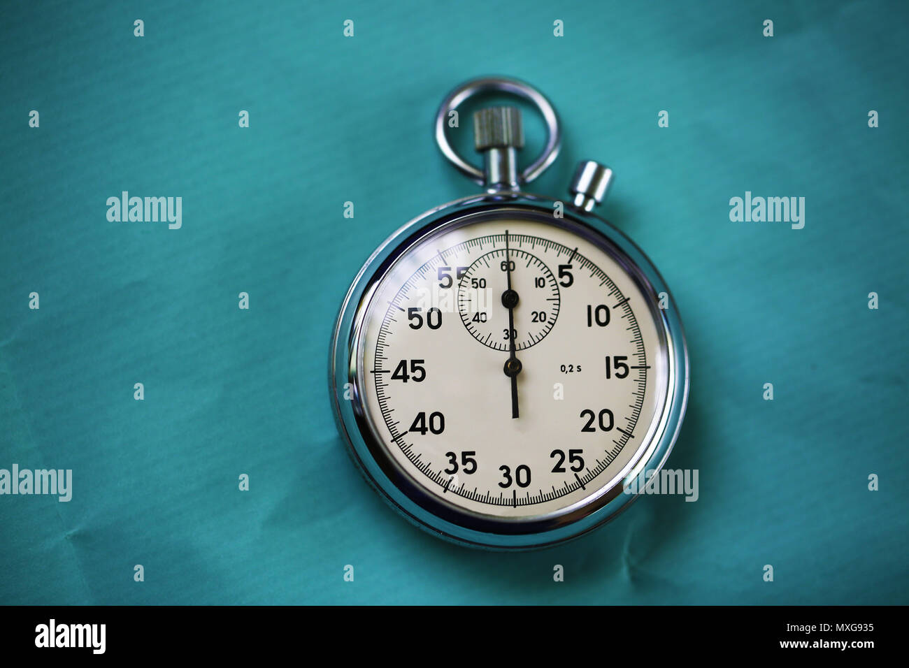 Old stopwatch isolated on paper bright background top view. Concept of ...