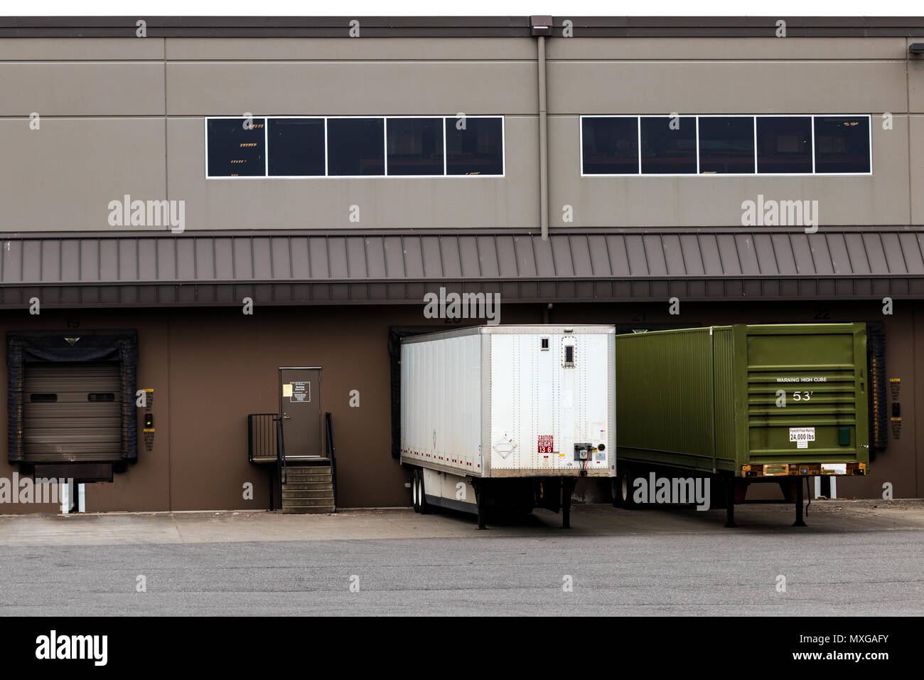 Tractor trailers at a warehouse cargo dock unloading Stock Photo - Alamy