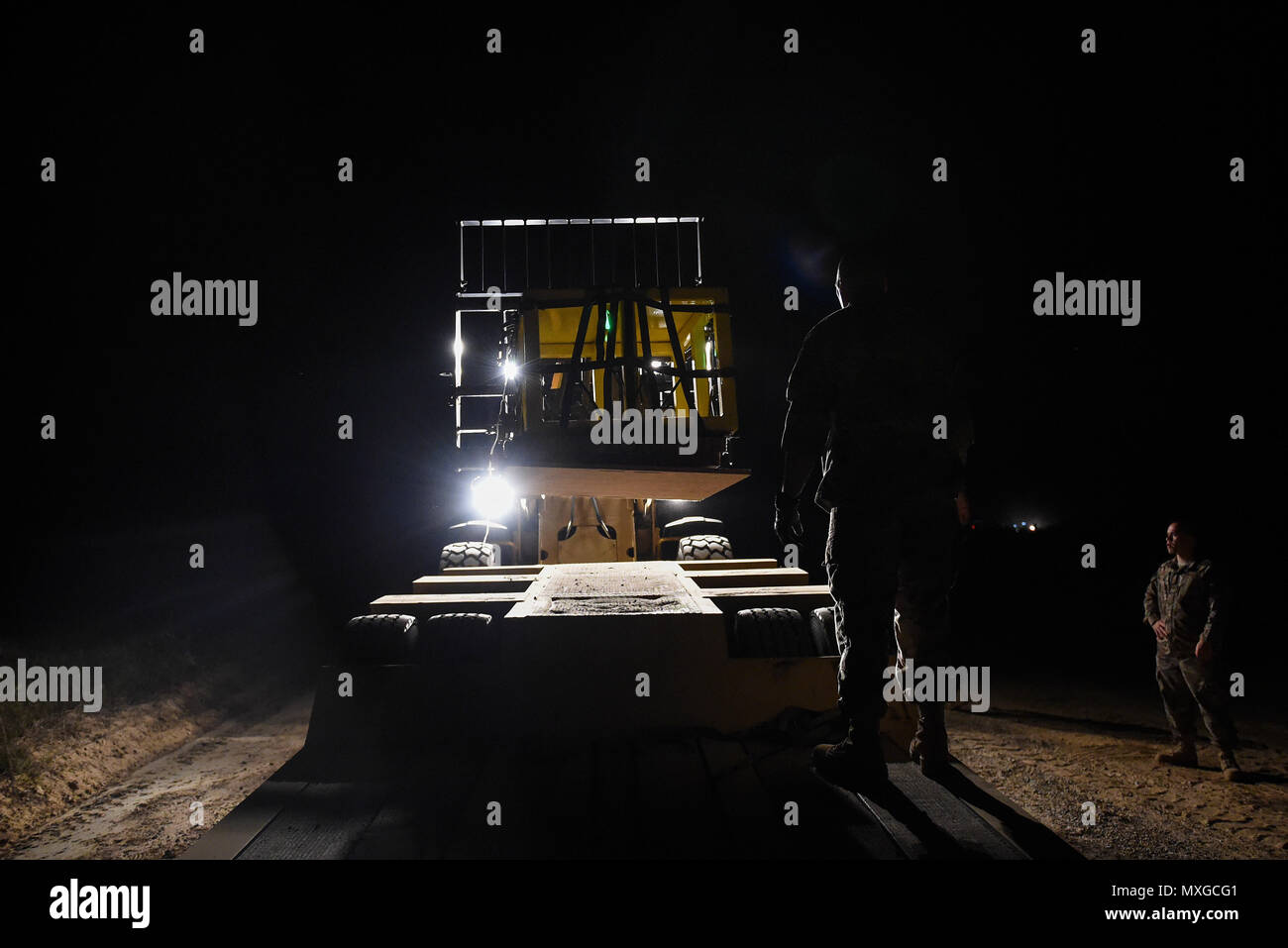 Air Commandos move cargo bundles onto a truck during Task Force ...